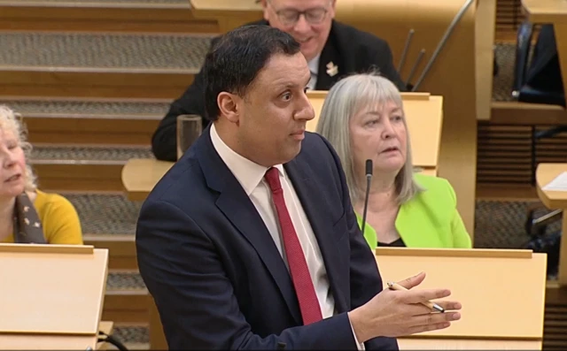 Swinney accused of 'miserly' tax cuts in the budget at FMQs - BBC News