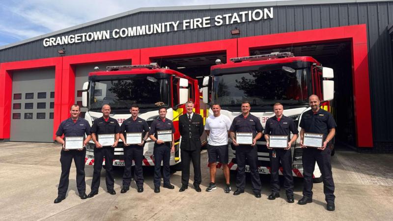 Cleveland firefighters honoured for saving colleague's life - BBC News