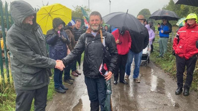 Lighthouse fan completes epic British coast walk for charity - BBC News