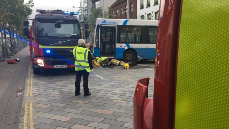 Belfast emergency services free person trapped under bus - BBC News