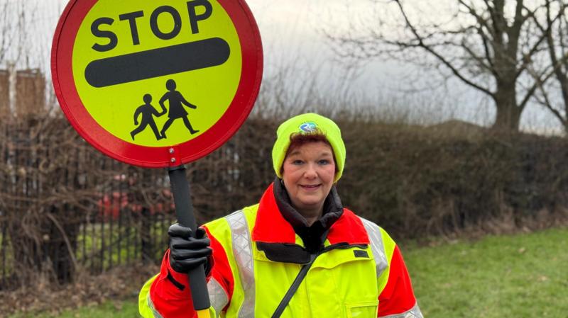 Redcar lollipop lady fighting back after close calls on road - BBC News