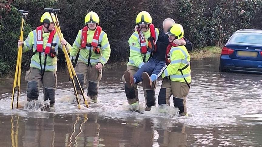 Essex fire crews rescue man from car in flood water - BBC News