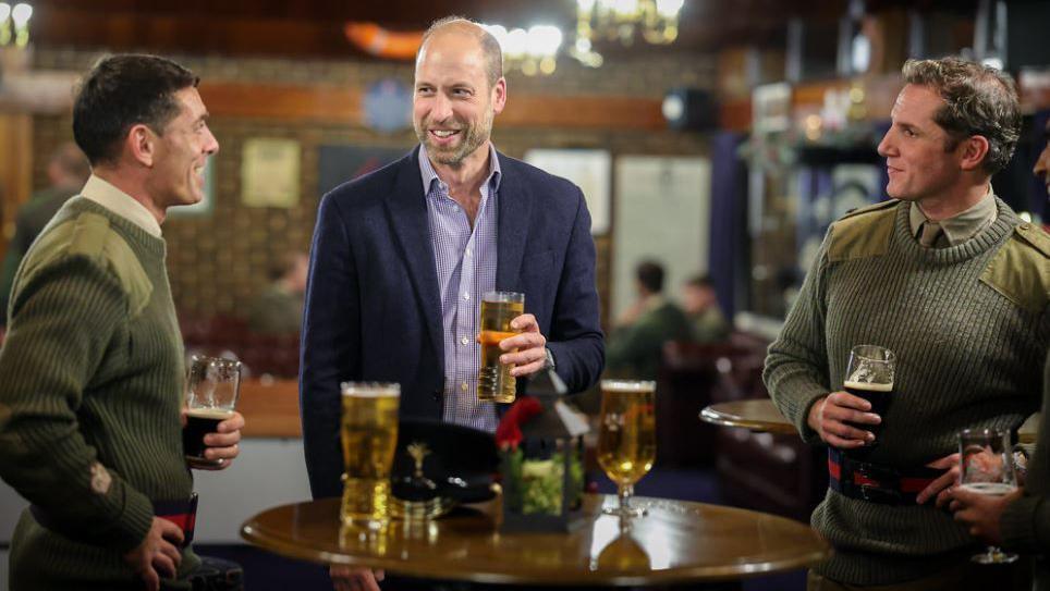 Prince William shares pint and serves pudding at Welsh Guards ...