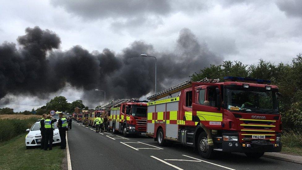 Homes evacuated after fire leads to explosions - BBC News