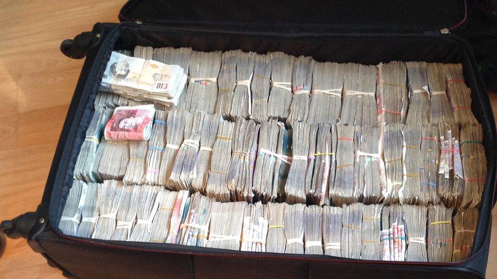 £530,000 cash and 12kg drugs found in Merseyside raids - BBC News