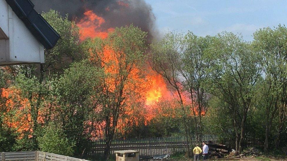 Firefighters tackle large pallet fire near Huncoat railway line - BBC News
