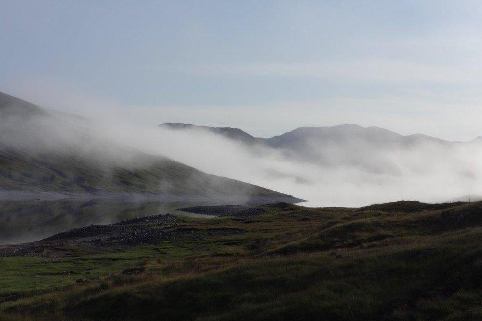 Drowned landscape revealed after levels drop at loch - BBC News