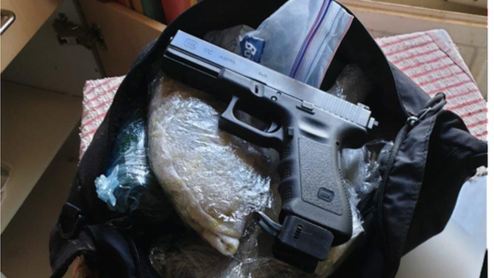 Police share image after bag of guns found by Sale passer-by - BBC News
