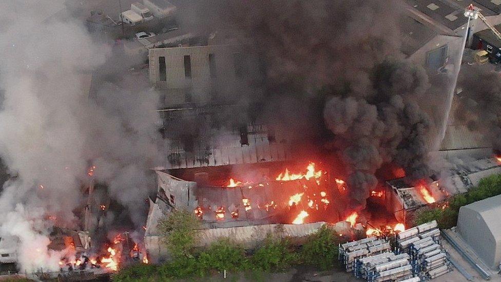 Manchester fire crews tackle huge blaze at industrial site - BBC News
