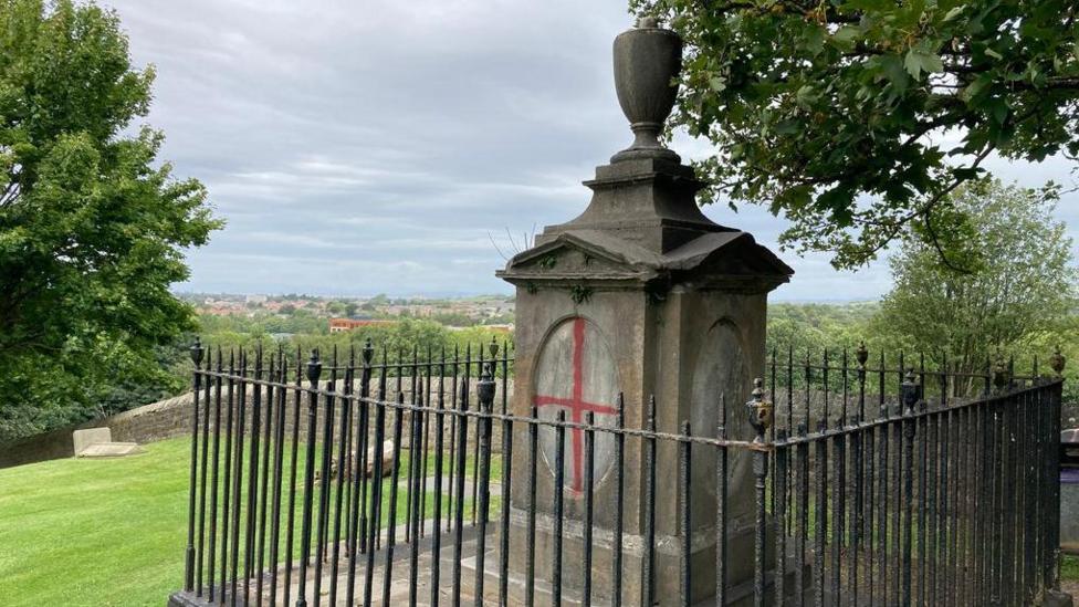 Lancaster slave traders' gravestone defaced with red cross - BBC News