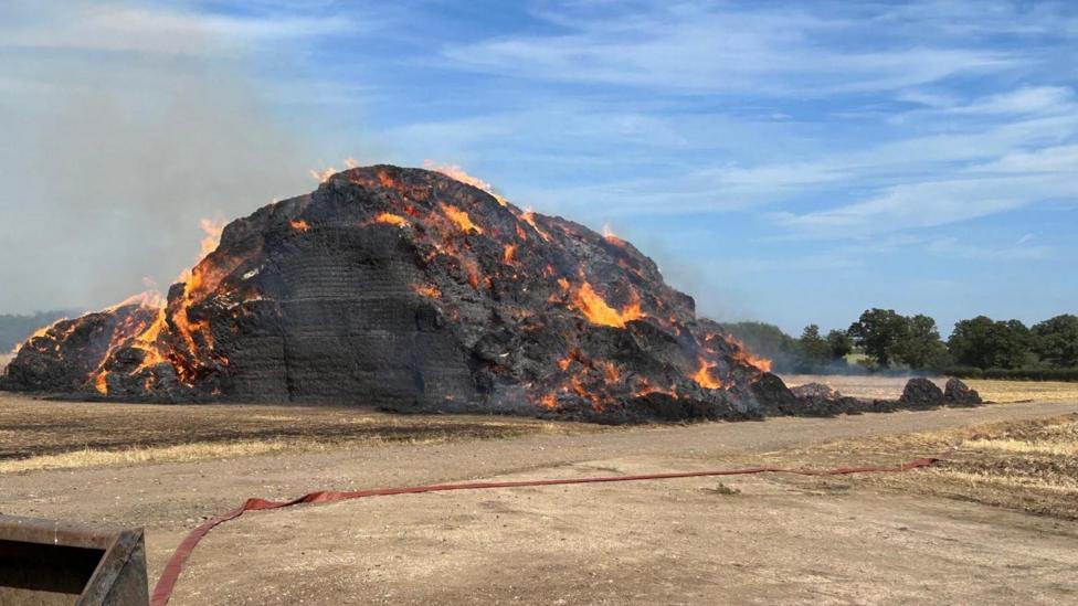 Fire service remains at scene of straw fire near Harleston - BBC News