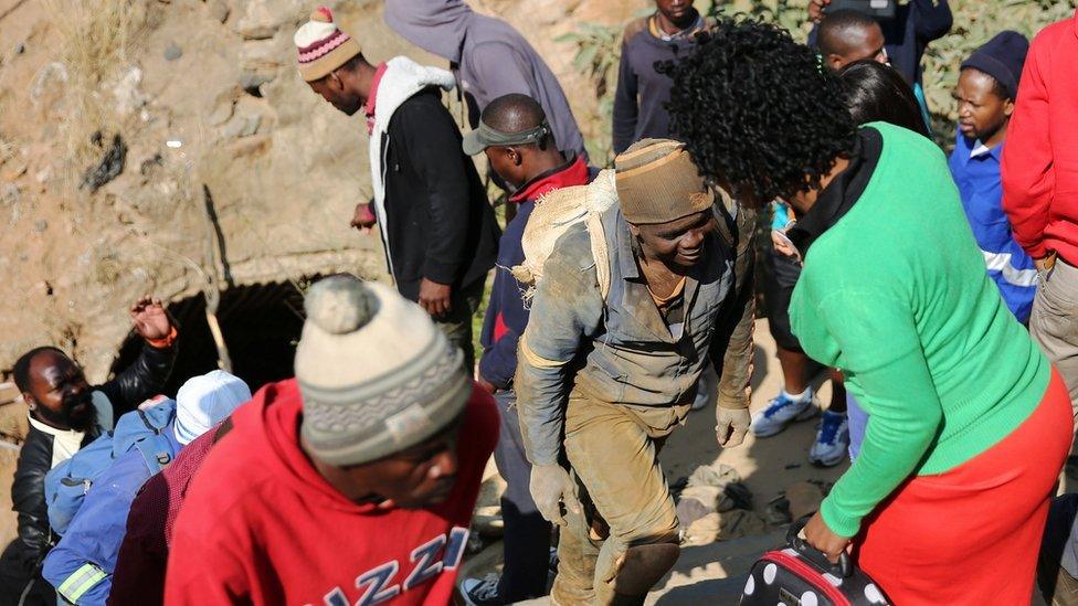 South Africa: Three miners emerge after days of being trapped - BBC News