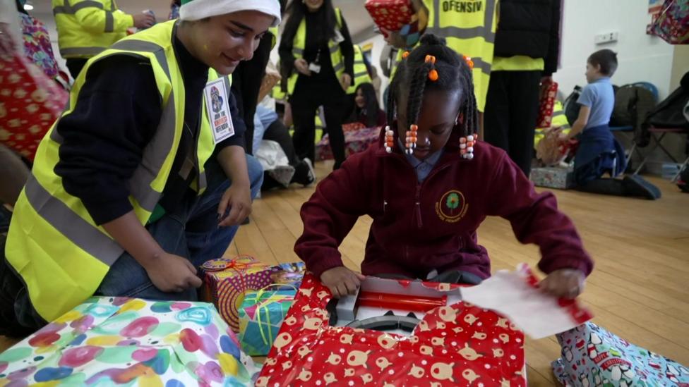 Christmas gifts wrapped for children across London - BBC News