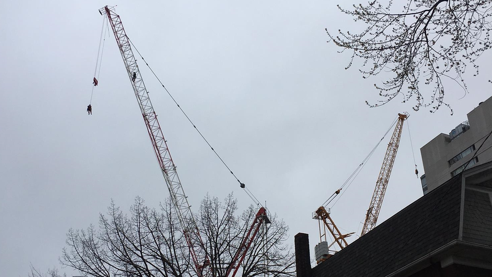 Toronto firefighters rescue woman stranded on crane - BBC News