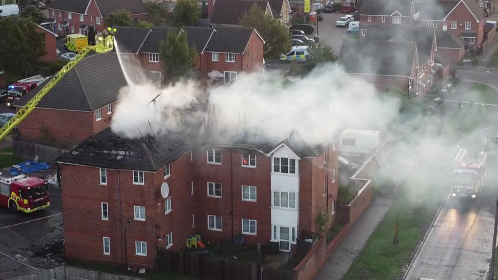 Children in hospital after fire rips through Enfield flats - BBC News