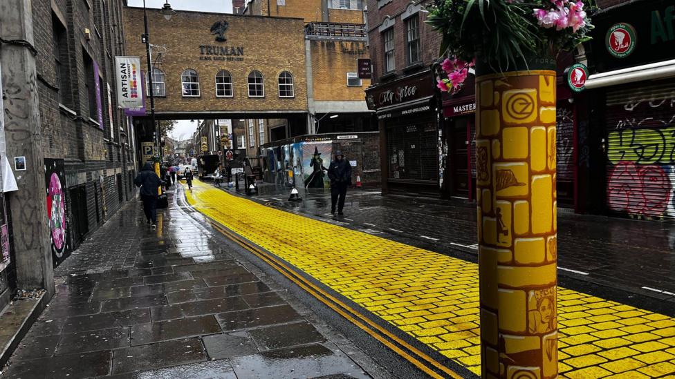 Brick Lane painted yellow to celebrate release of new Wicked film - BBC ...