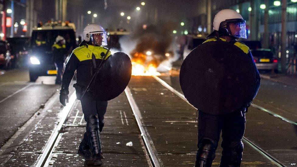 Dutch police detain 200 after riot in The Hague - BBC News