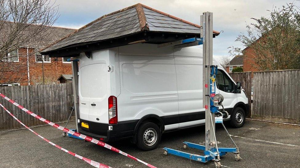 Van gets stuck under car park canopy in Exeter - BBC News