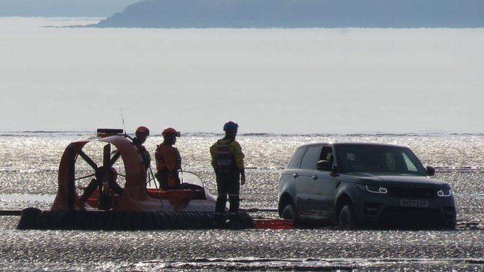 Range Rover test driver rescued by hovercraft on mudflats - BBC News