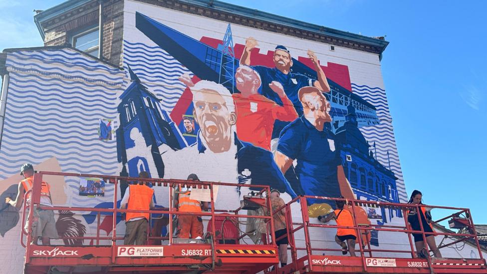 Ipswich waterfront new banner featuring octopus mascot unveiled - BBC News