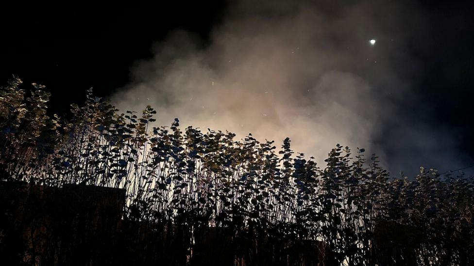 Shut windows and doors warning after large barn fire in Devon - BBC News