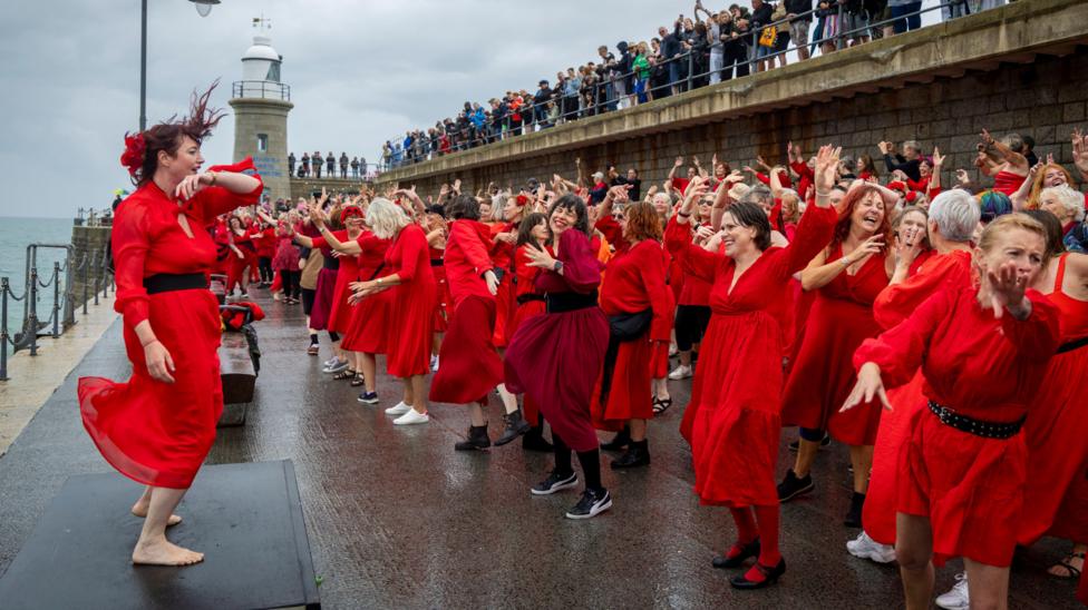 Rain-soaked fans recreate Wuthering Heights dance in Folkestone - BBC News