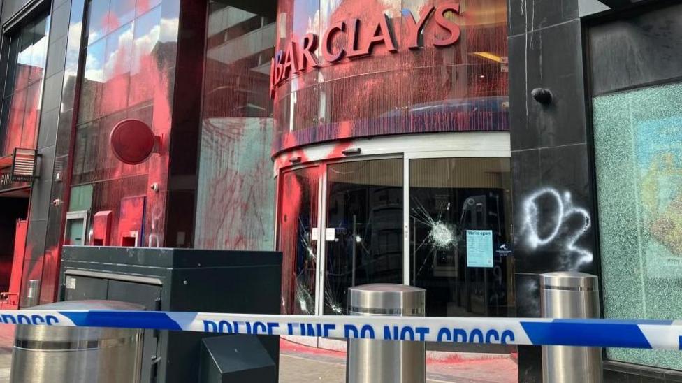 Barclays paint attack: Seven deny criminal damage charges - BBC News