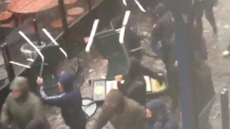 Football fans charged after chair fight in Manchester - BBC News