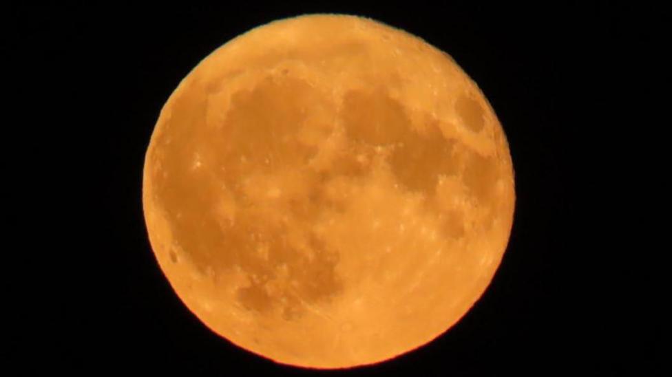 Orange Buck Moon captured across the south of England - BBC News