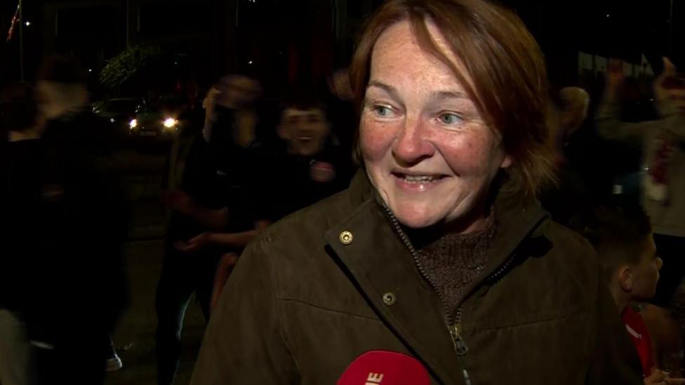 Larne fans 'over the moon' as 10-man team makes history - BBC News