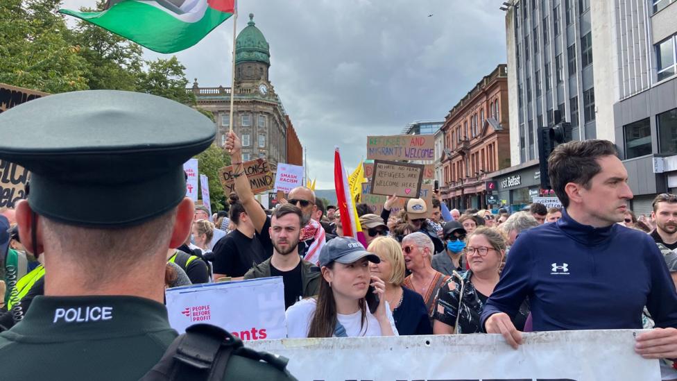 Anti-racism campaigners march in central Belfast - BBC News