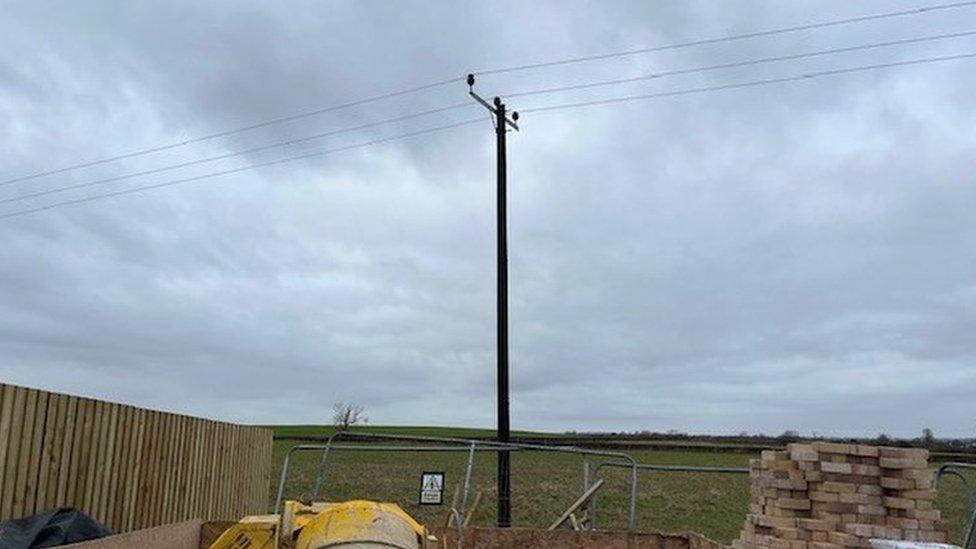 Row over electricity pole delays new Seend Cleeve homes - BBC News