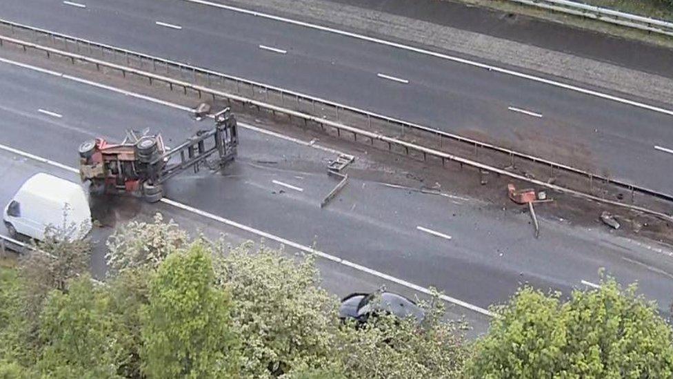 Major delays on M74 after forklift falls off lorry - BBC News