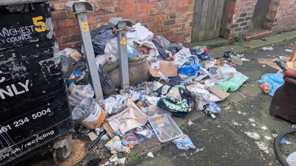Manchester: 'We're forced to climb over rubbish piling up outside our ...