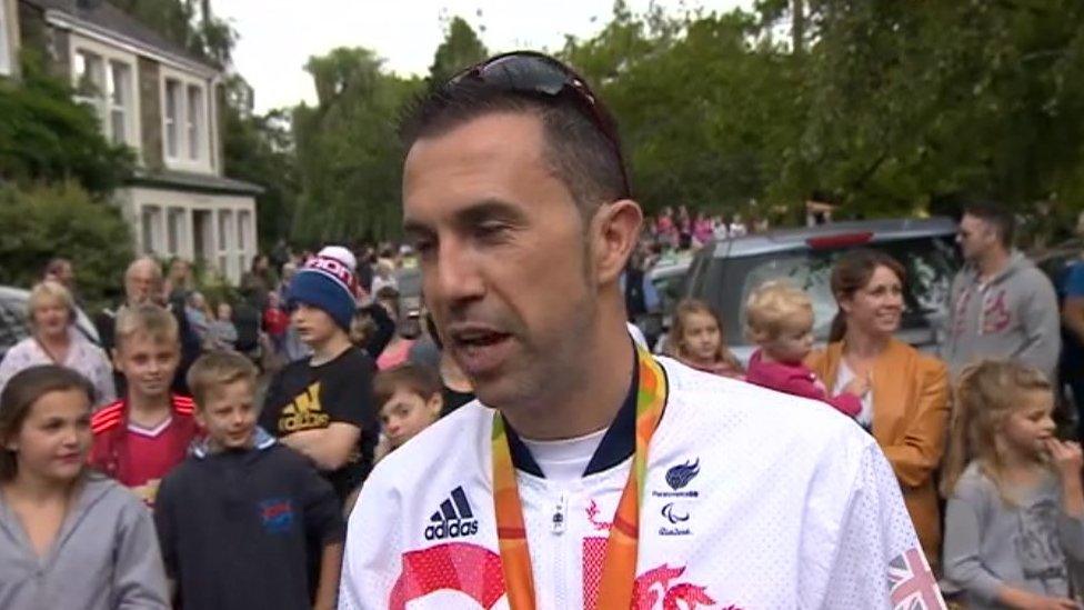 Lydney homecoming for Paralympic triathlete Andy Lewis - BBC News