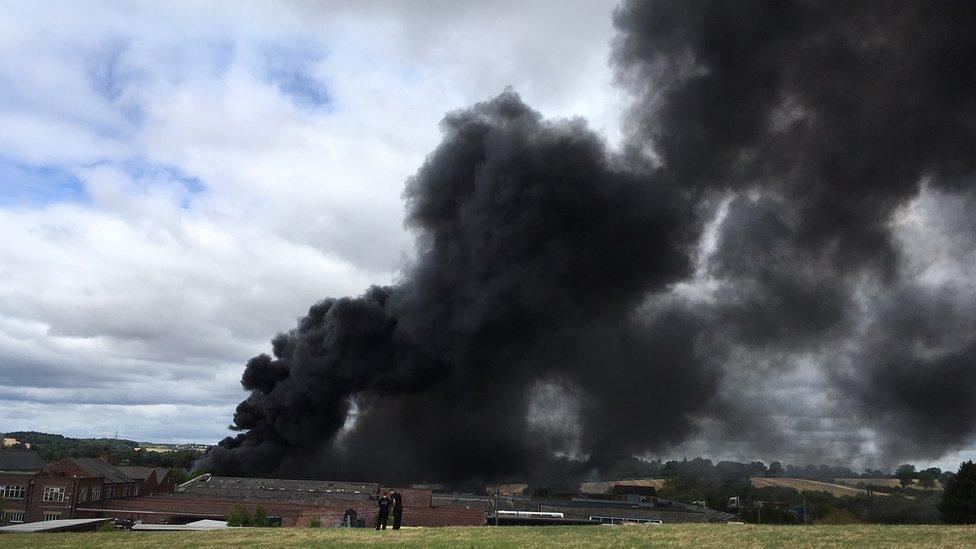Homes evacuated after fire leads to explosions - BBC News