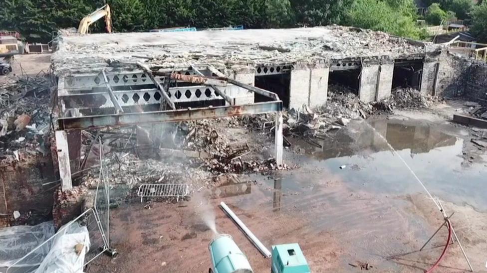 Fire and asbestos complicate old Norwich shoe factory demolition - BBC News