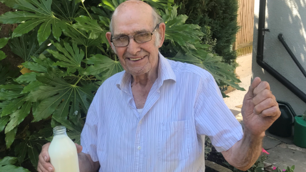 'Britain's oldest' milkman's coffin travels on milk float - BBC News