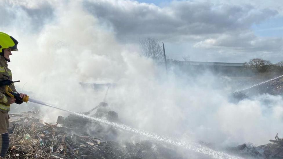 Crews tackle waste and tyres fire at yard near Basildon and A127 - BBC News