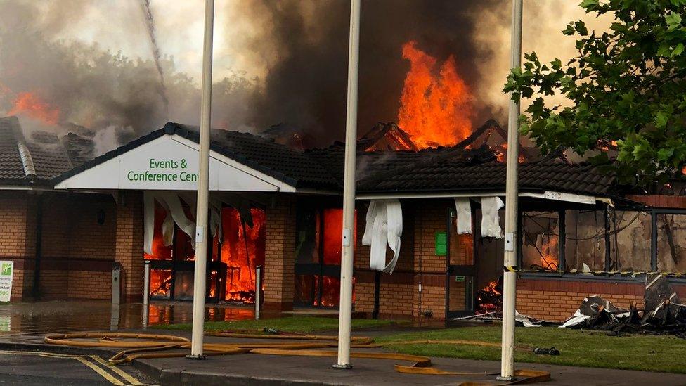 Holiday Inn destroyed by fire 'too dangerous to enter' - BBC News