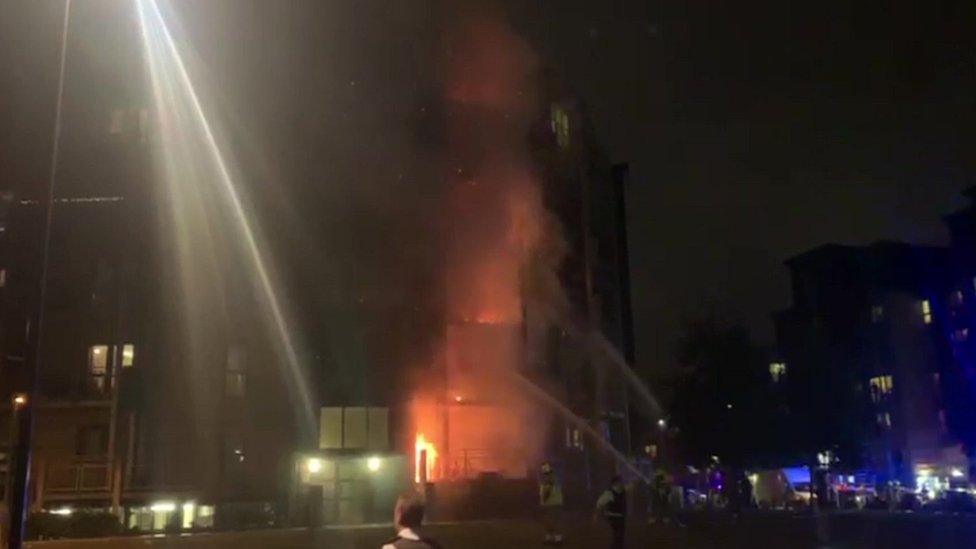 Clapton flats fire: Woman rescued during 'suspicious' blaze - BBC News