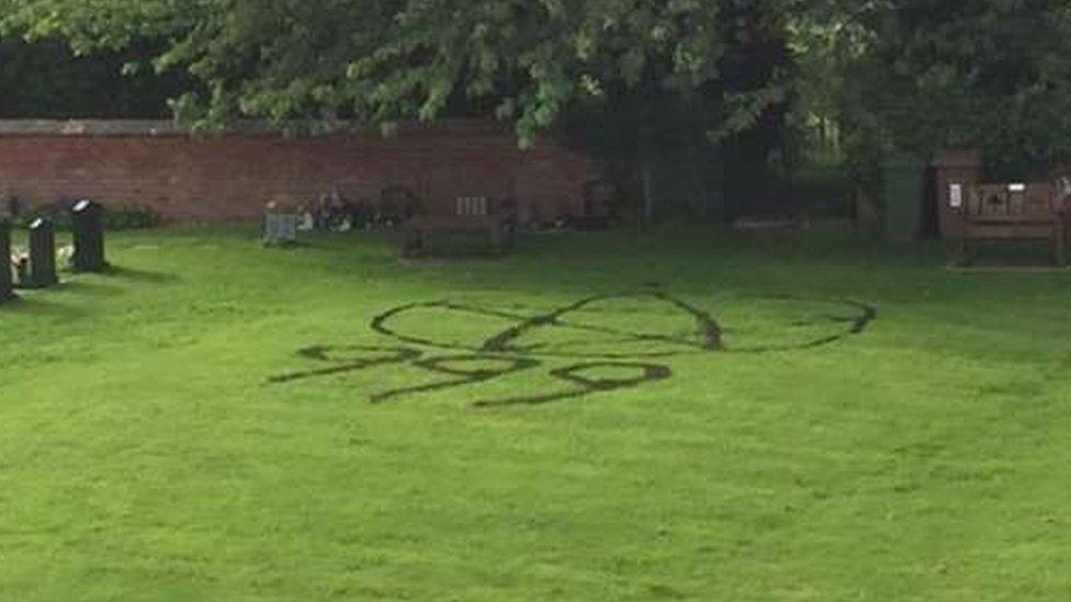 '666' spray attack on cemetery in Burstwick - BBC News