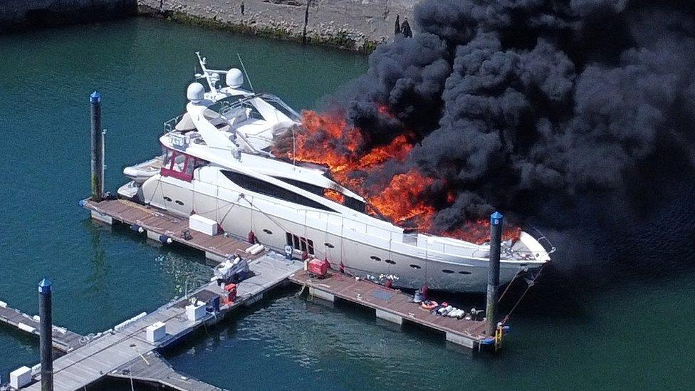 Superyacht fire: 'Clean-up before salvage' in Torquay - BBC News