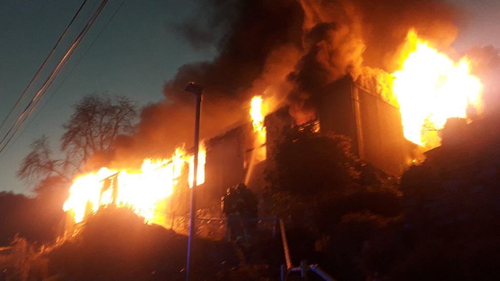 Buckley fire: Major blaze at antique book firm Berwyn Books - BBC News