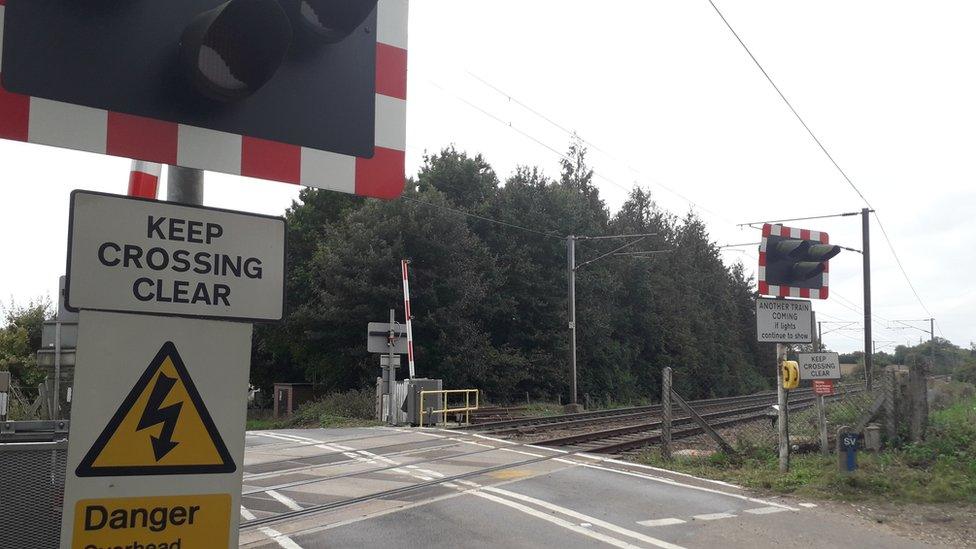 Motorist dies after train hits car at Suffolk level crossing - BBC News