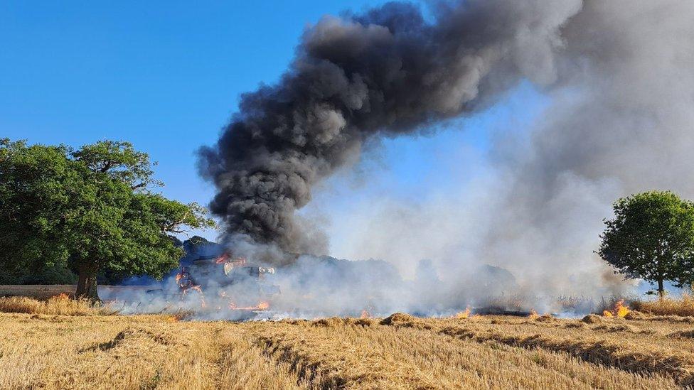 Combine harvester fire in field at Soulton Hall grounds - BBC News