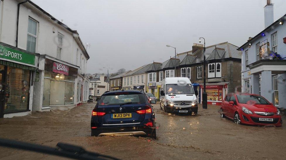 Flooding shuts roads and blocks rail lines in south of England - BBC News