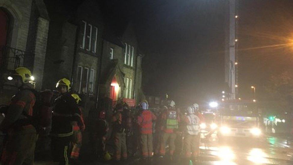 Firefighters tackle rectory roof fire in Oldham - BBC News