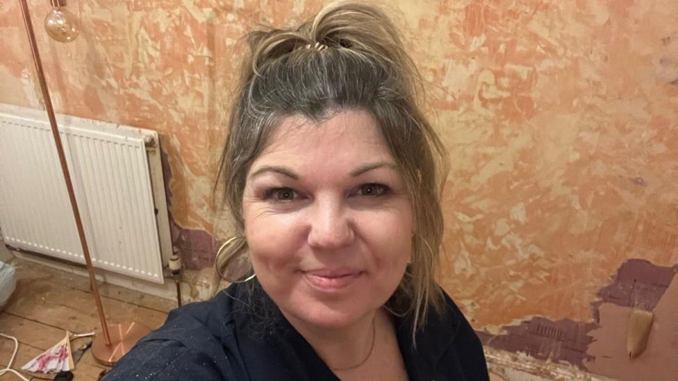 Cost of living sees homeowner renovating her house herself - BBC News