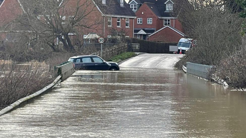 Floods update: Boy rescued as danger remains across the region - BBC News
